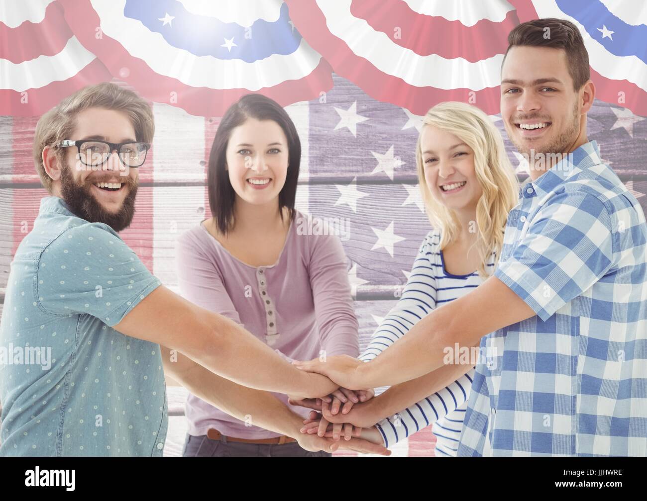 Smiling Friends with hands together against american flag Stock Photo ...