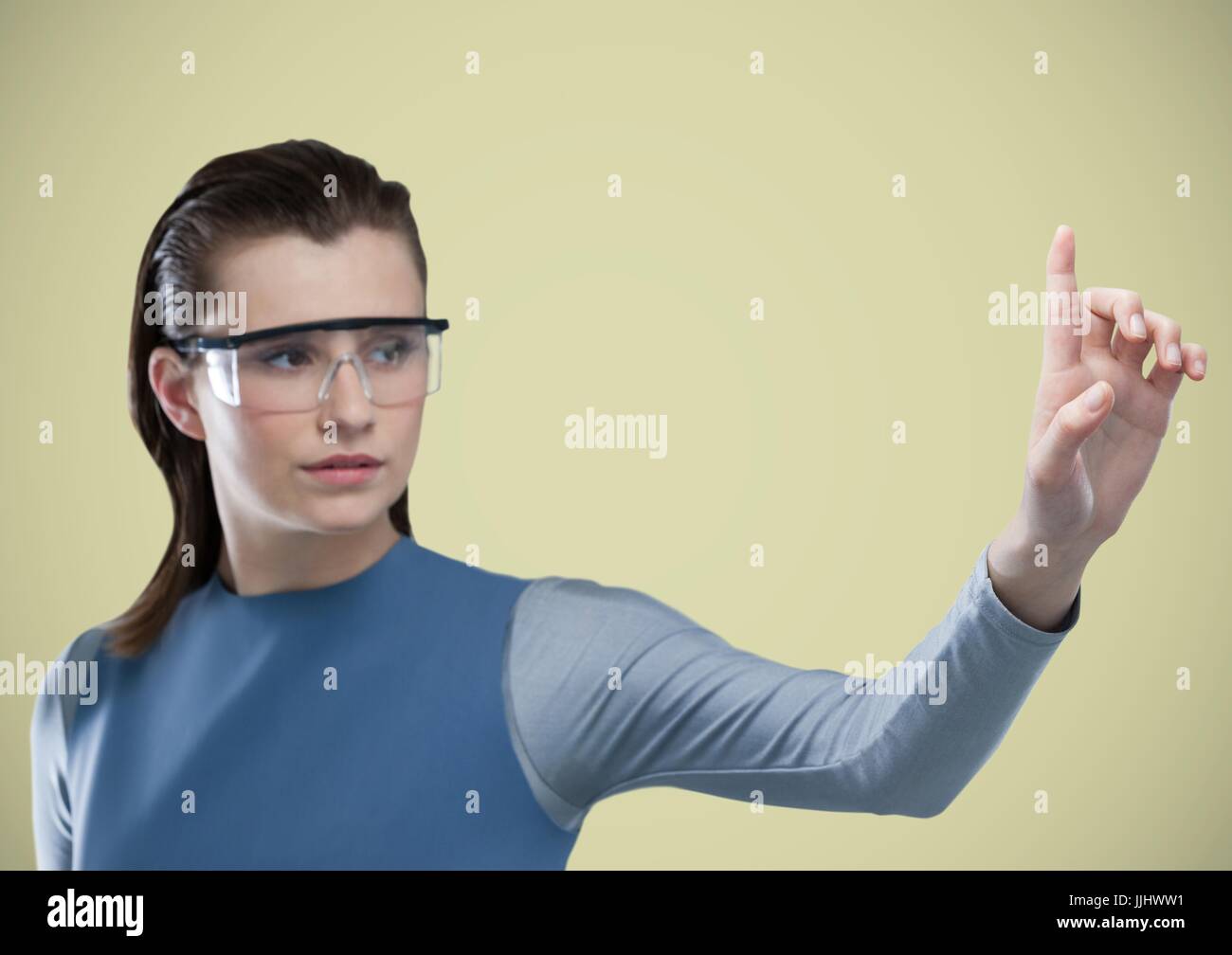 Woman in virtual reality headset against light green background Stock ...