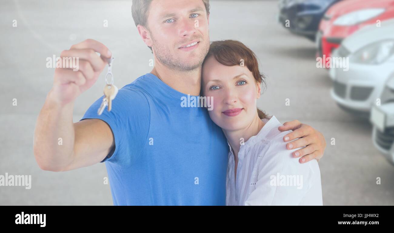 Couple Holding Keys with cars Stock Photo - Alamy