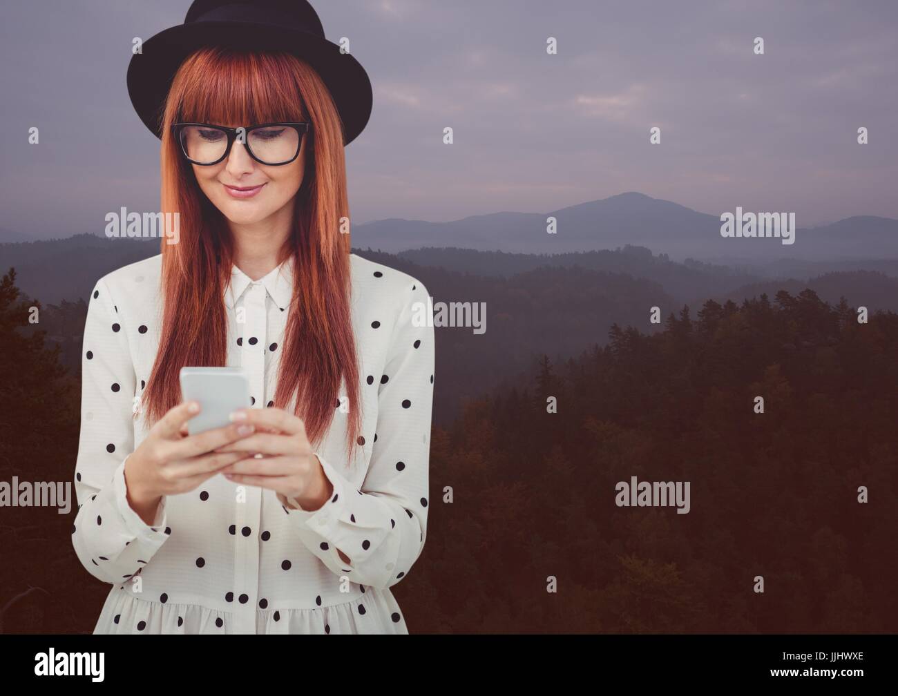 Smiling woman texting in countryside background Stock Photo - Alamy