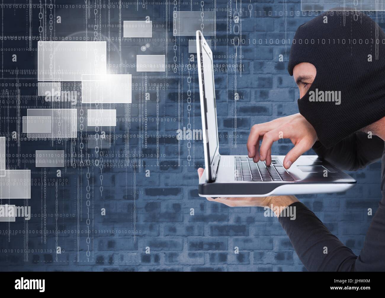 Hacker using a laptop in front of digital background Stock Photo - Alamy