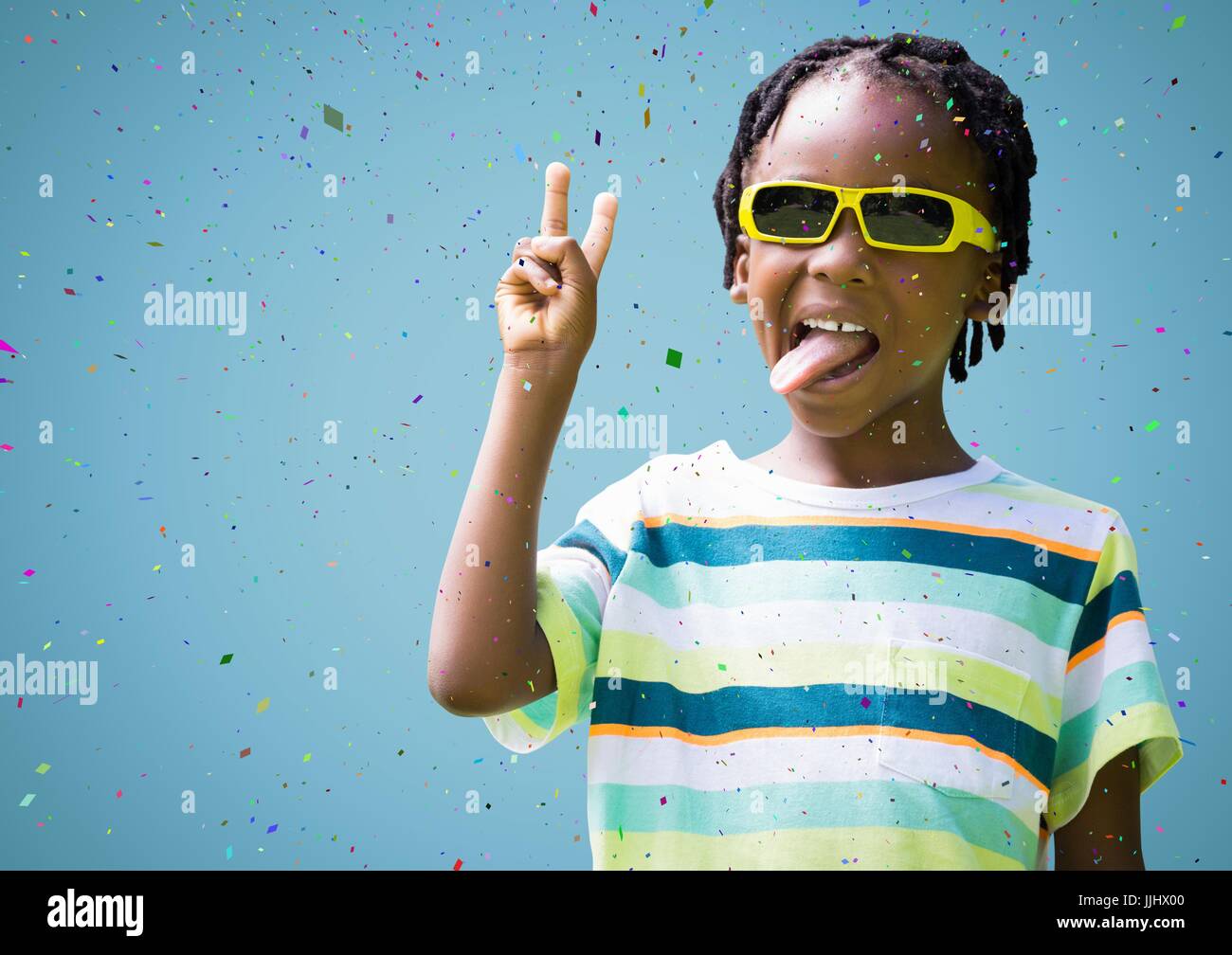 Boy in sunglasses making peace sign against blue background and ...