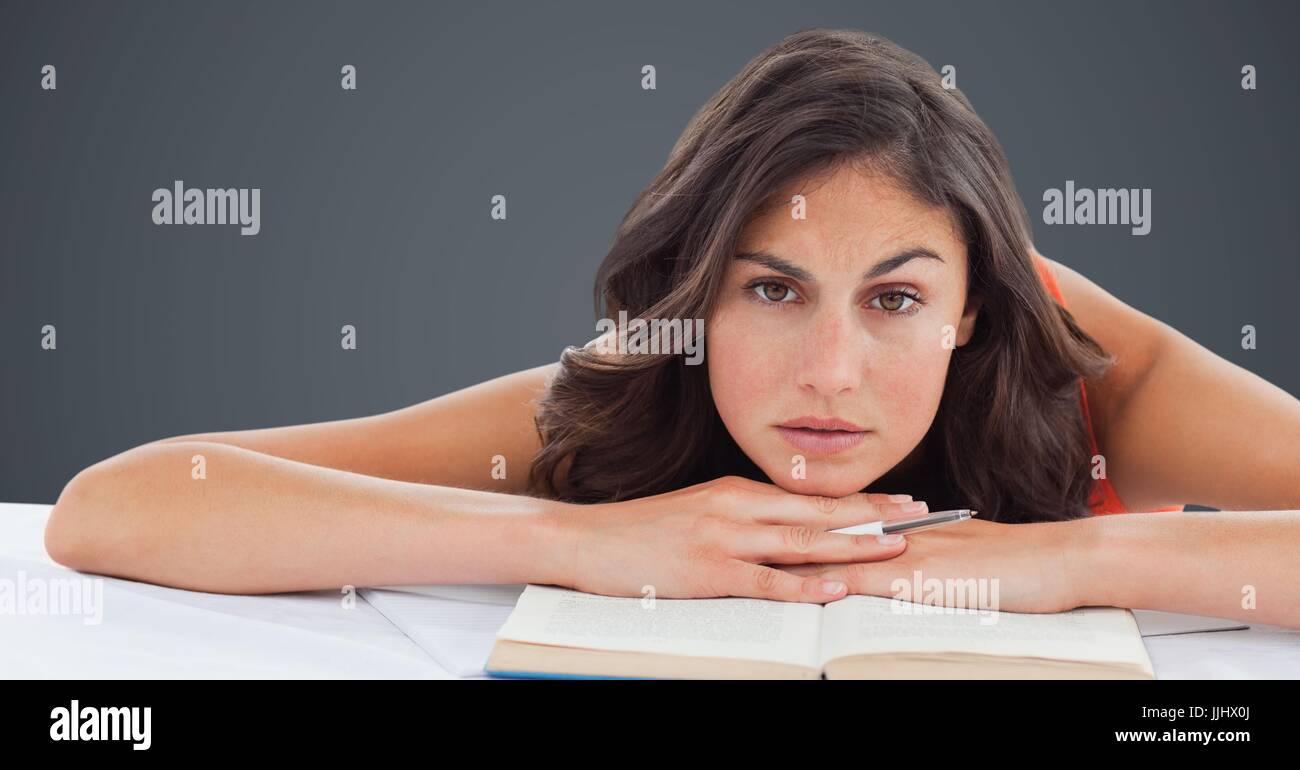 College student at desk against grey background Stock Photo - Alamy