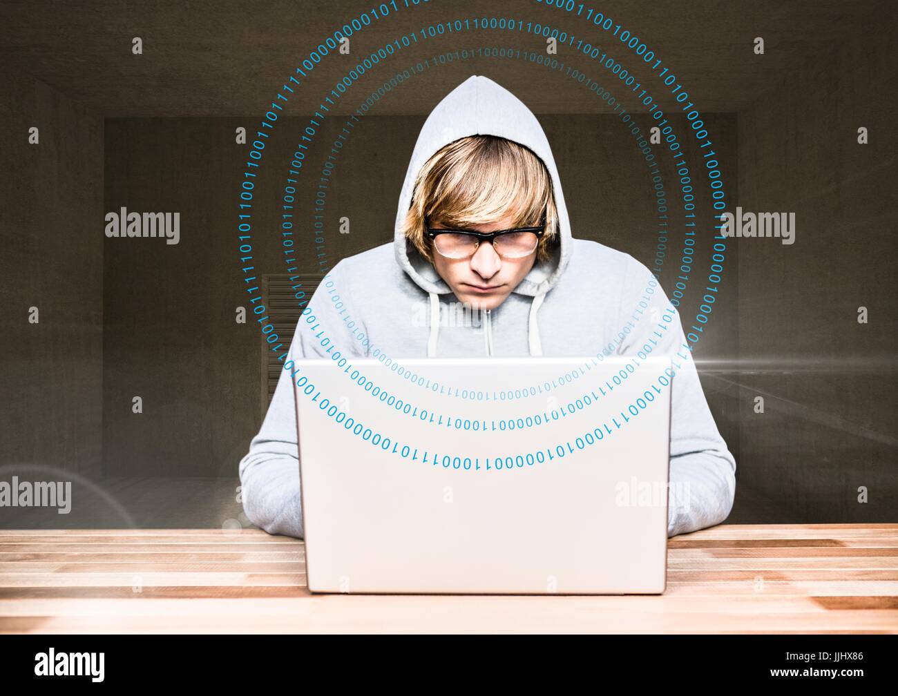 Blond hair hacker using a laptop in a room Stock Photo - Alamy