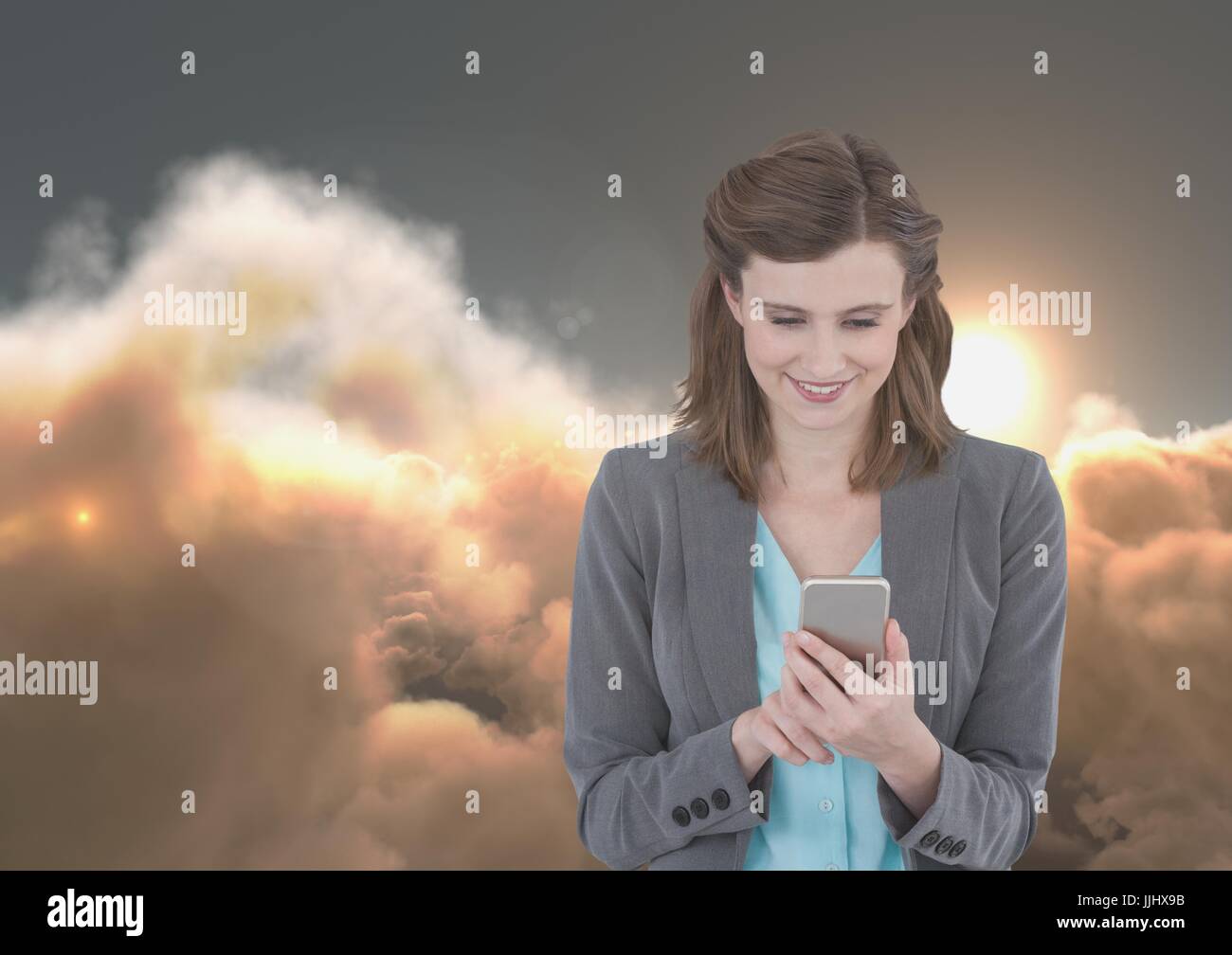 Smiling woman texting in 3D cloudy background Stock Photo - Alamy