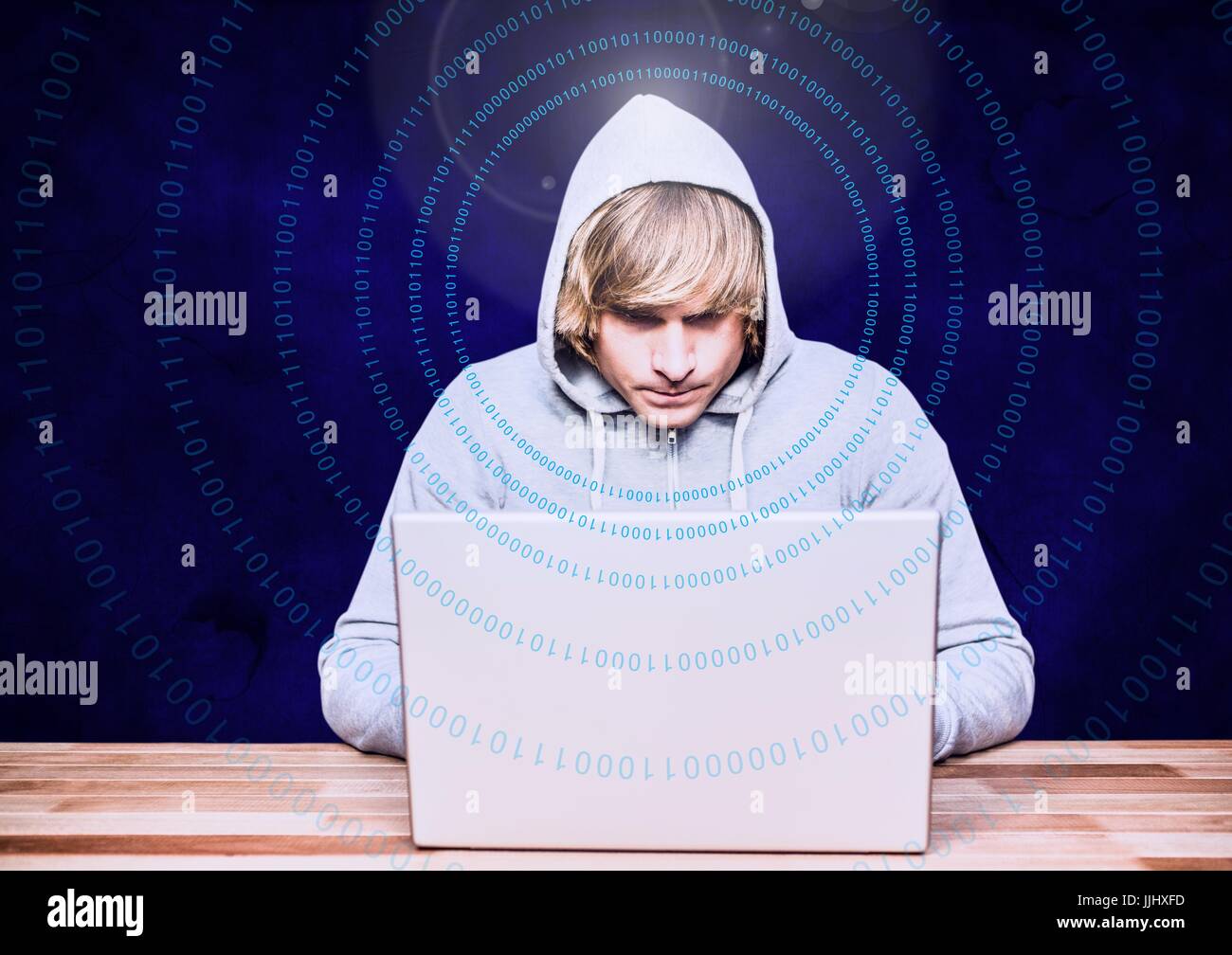 Blond hair hacker using a laptop in front of blue background Stock ...