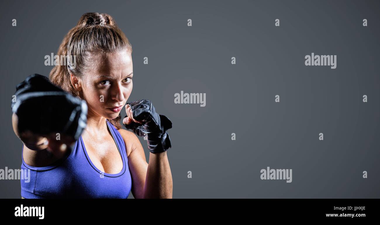 Female boxer against grey background Stock Photo - Alamy