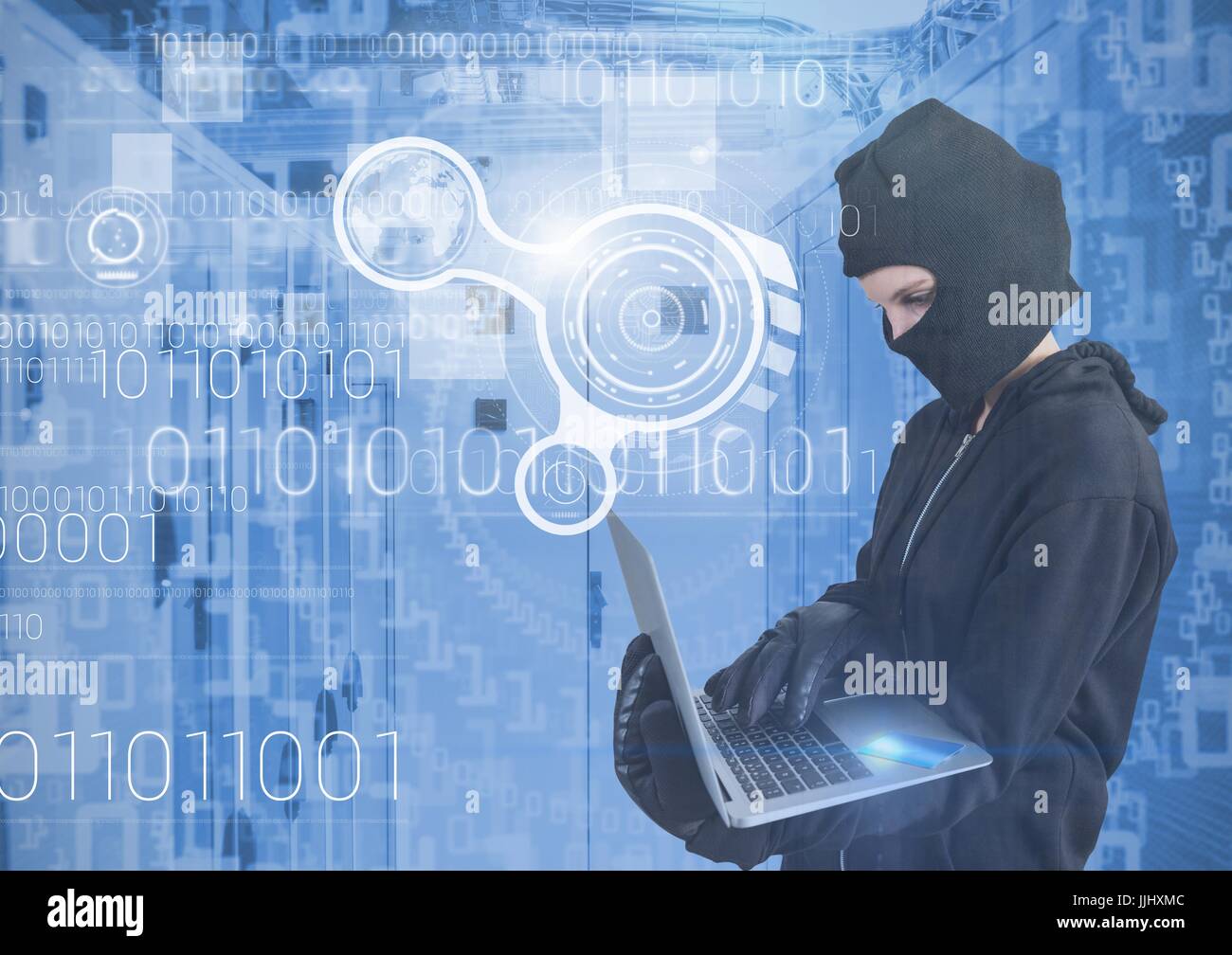 Woman hacker with hood using a laptop in data center Stock Photo - Alamy