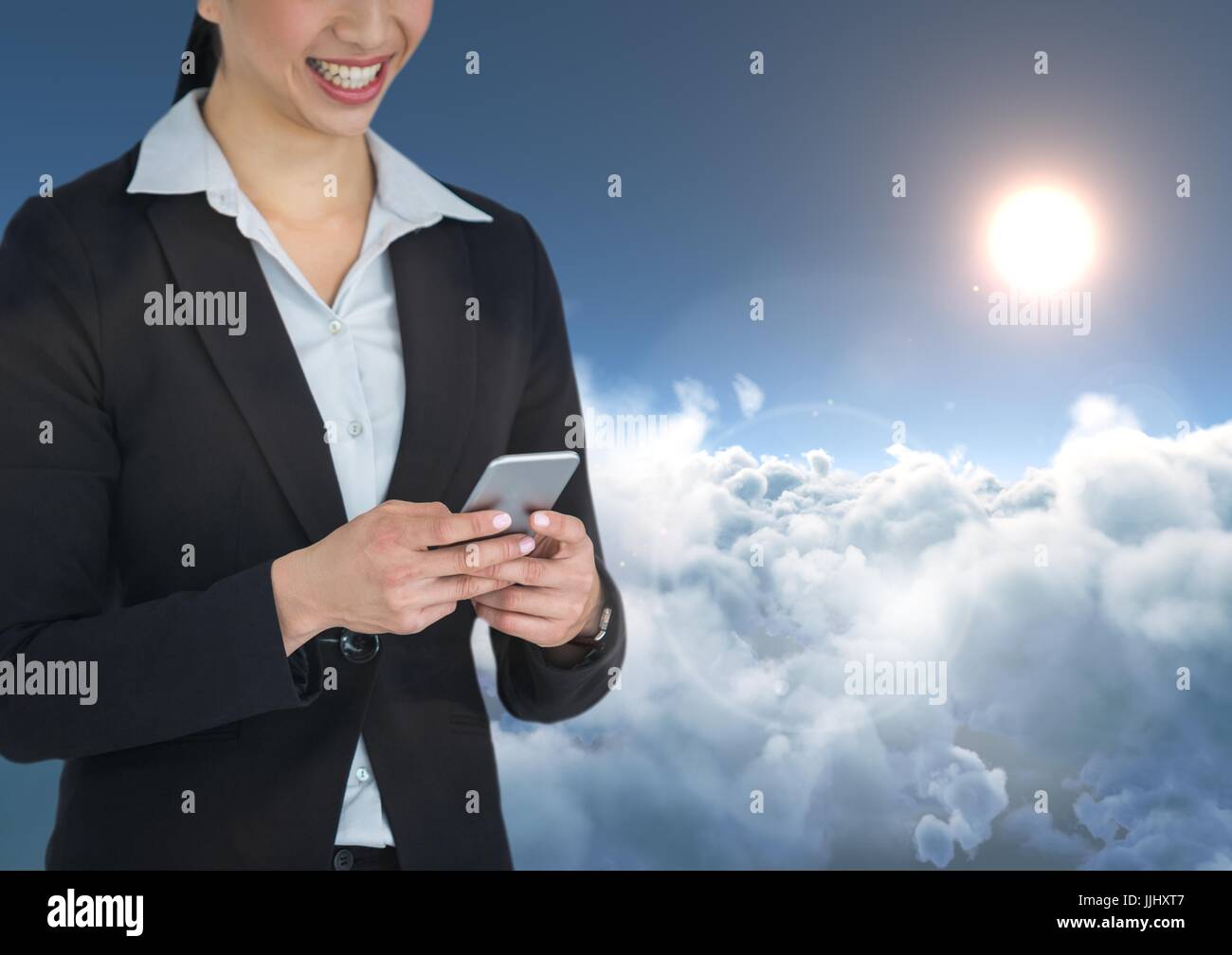 Smiling woman texting in 3D cloudy background Stock Photo - Alamy