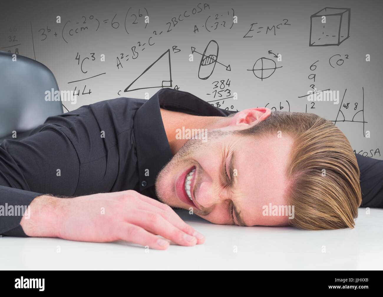 Frustrated business man on desk against grey background and math ...