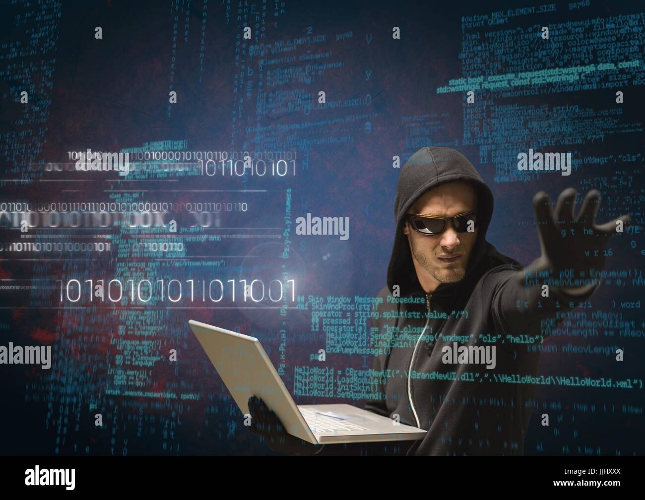 Hacker holding a laptop and extending his arm in front of 3D digital ...