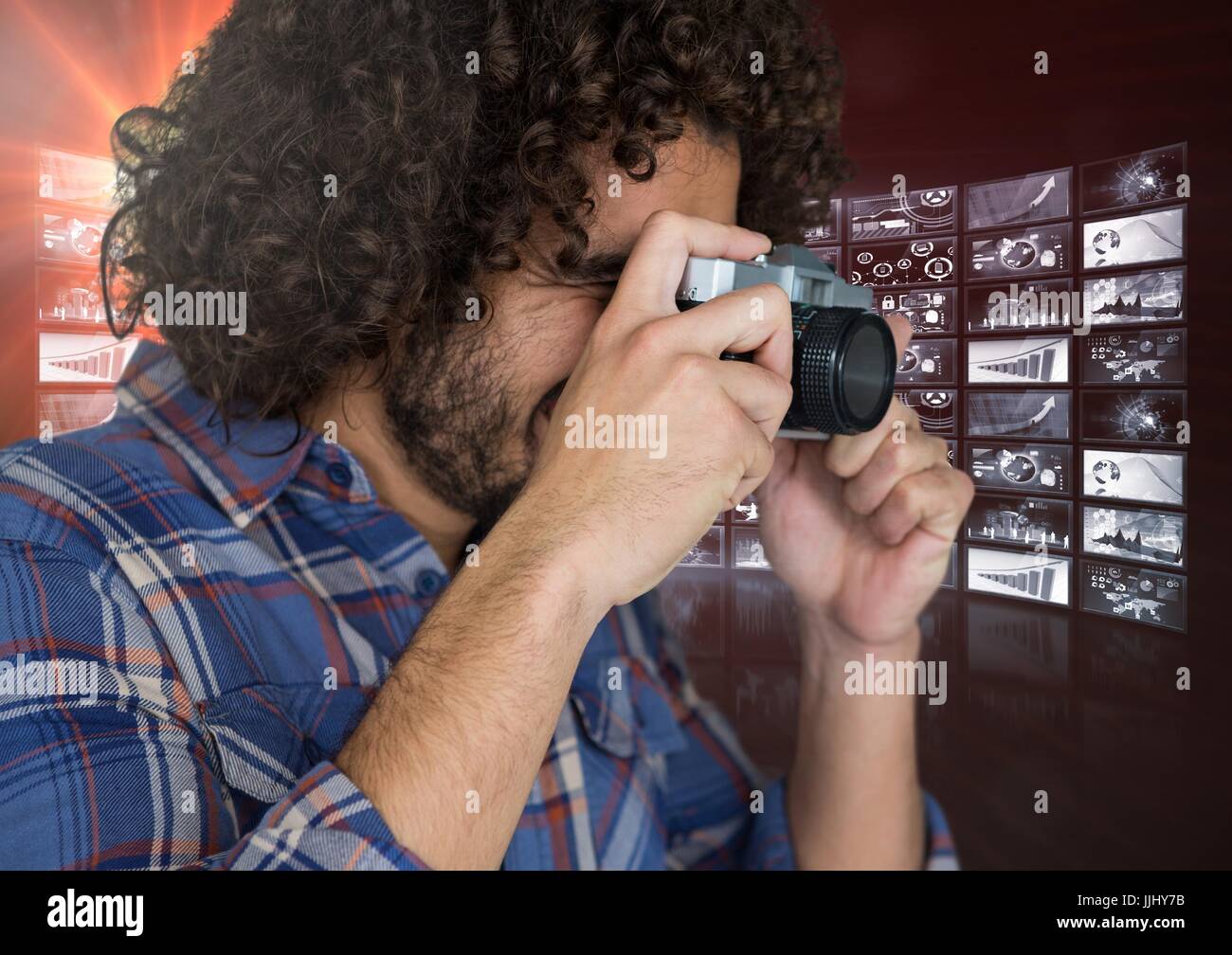 photograph taking picture with his camera against screens Stock Photo ...