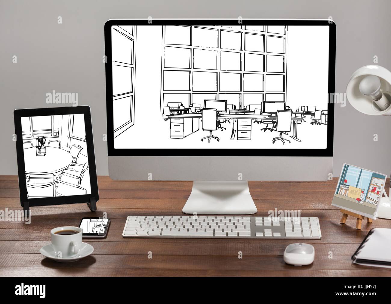 desk with tablet, computer and phone. 1 office blueprint in each one ...