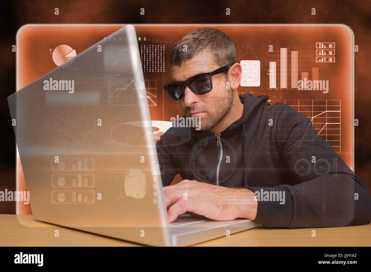 Hacker using a laptop on orange interface Stock Photo - Alamy