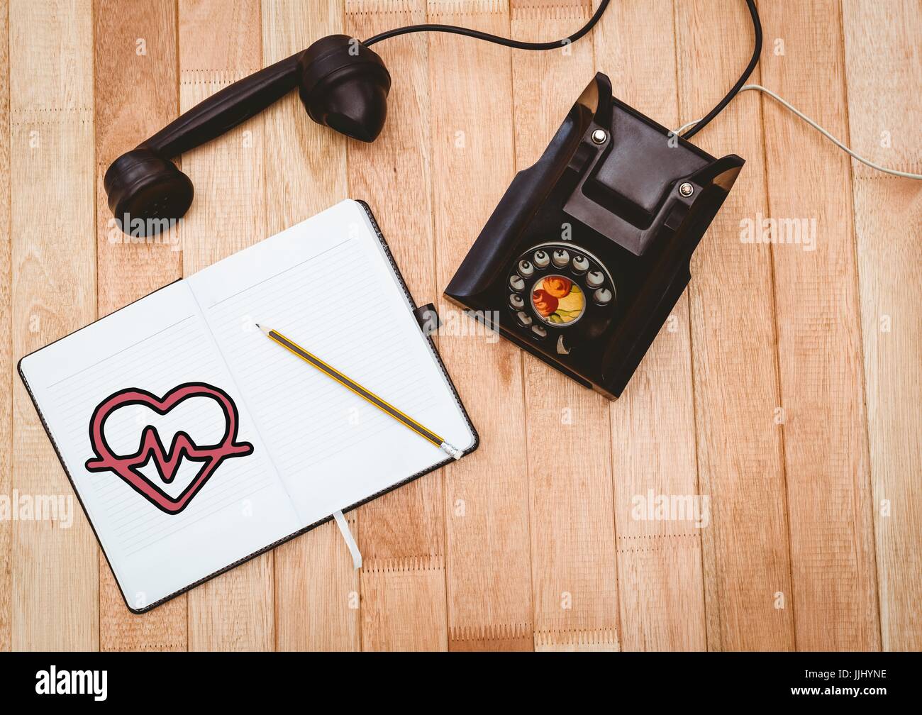 Heart doodle on notepad next to black vintage phone Stock Photo - Alamy