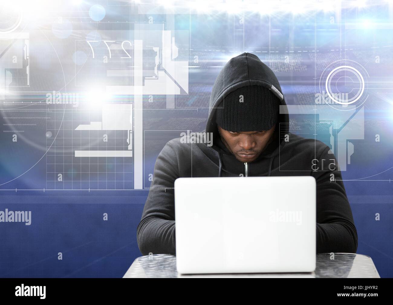 Hacker using a laptop in front of blue digital background Stock Photo ...