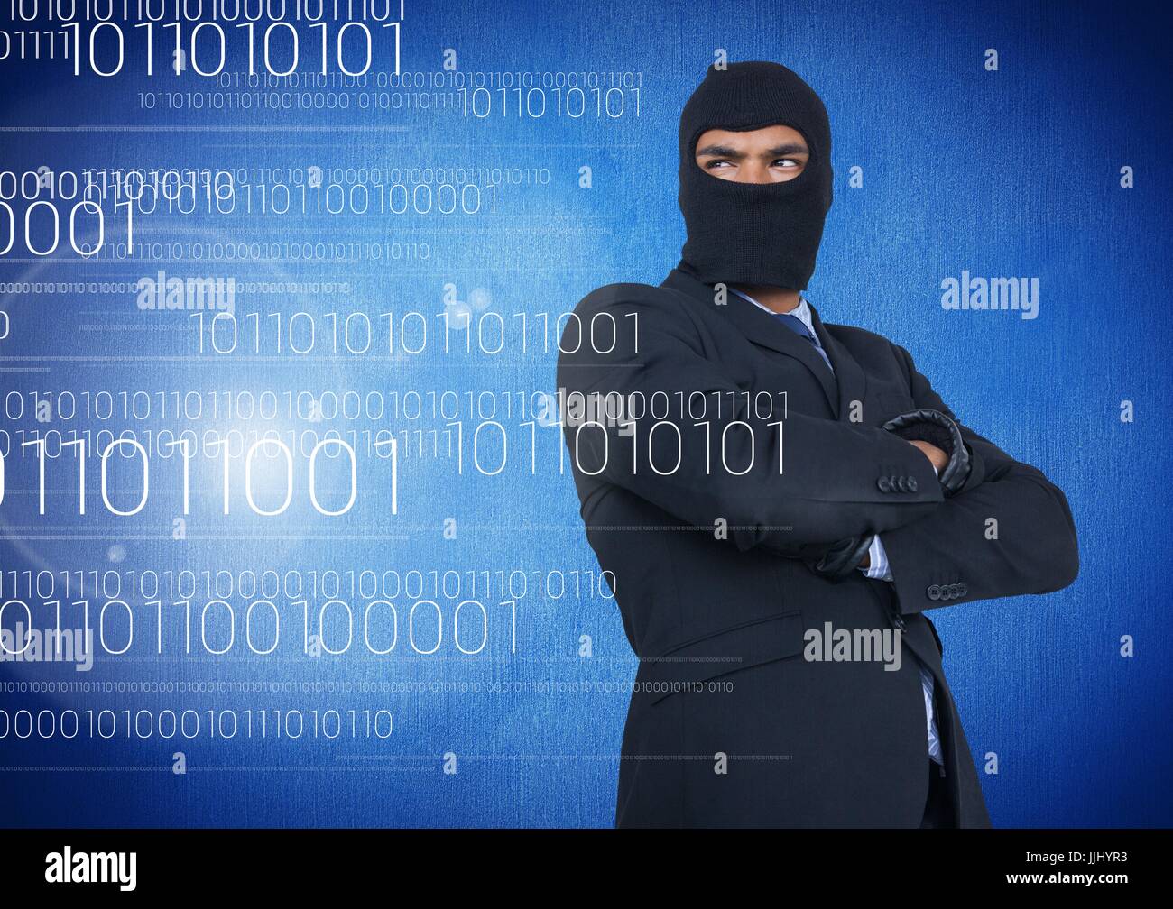 Hacker with hood and arms crossed standing on in front of blue ...