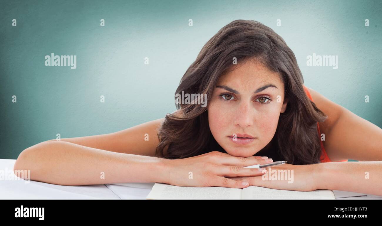 College student at desk against green background Stock Photo - Alamy
