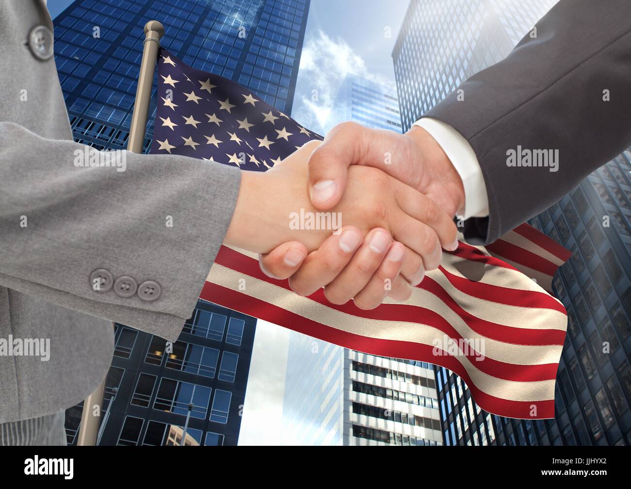 Business people shaking their hands against american flag and ...
