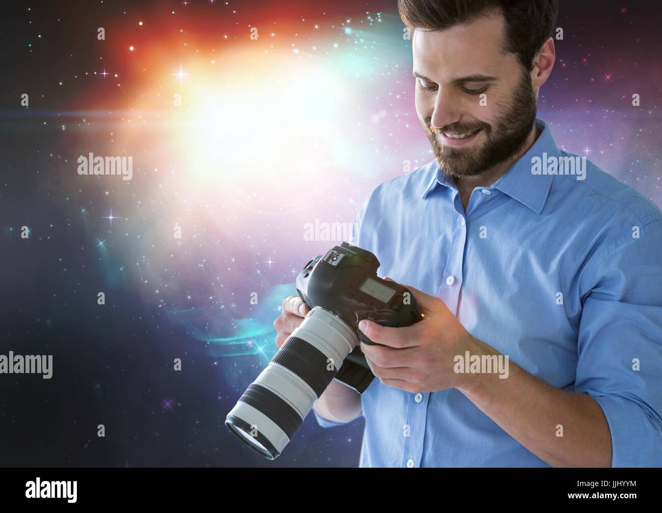 Photographer in front of lights looking his camera Stock Photo - Alamy