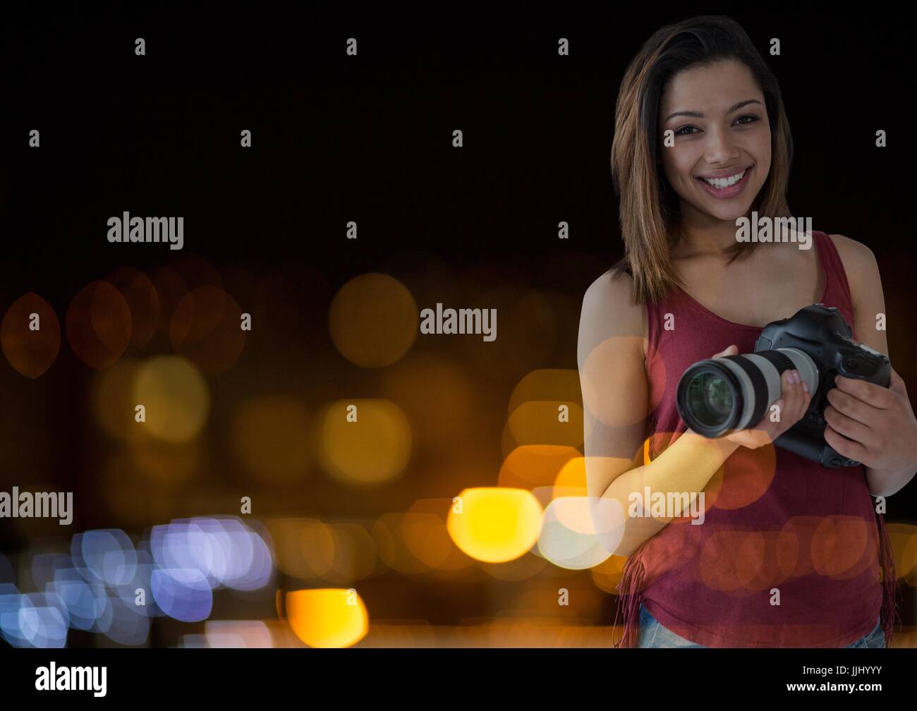 Photographer in front of lights bokeh Stock Photo - Alamy