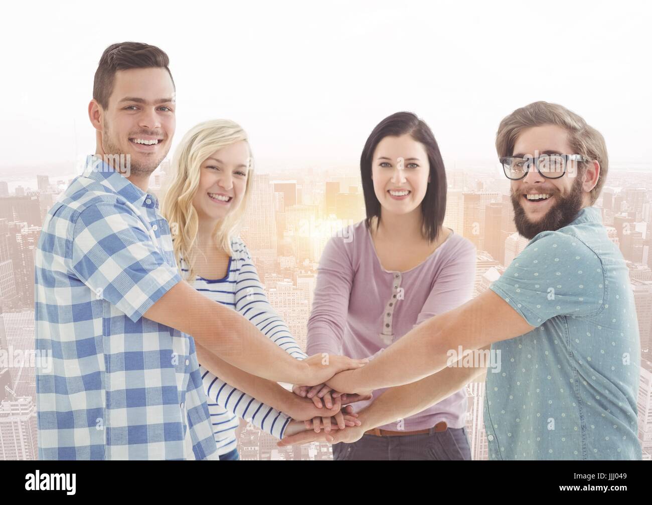 Smiling Friends with hands together Stock Photo - Alamy