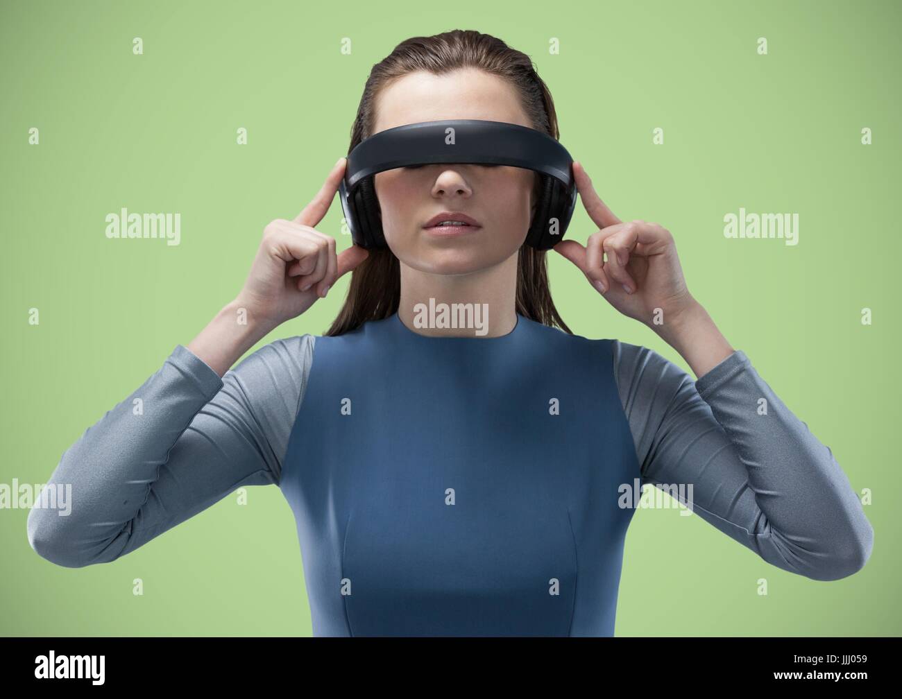 Woman standing against green hi-res stock photography and images - Alamy