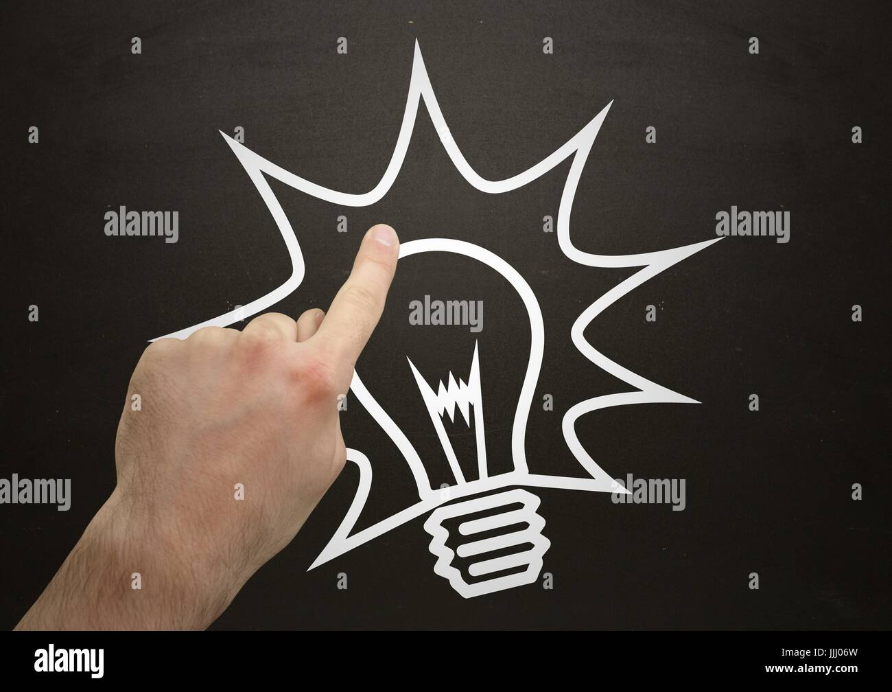 Hand pointing at blackboard and 3d white lightbulb graphic Stock Photo ...