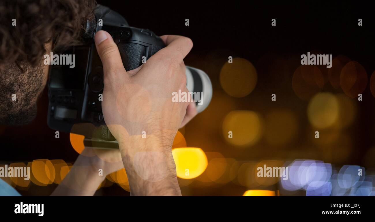 hands holding a camera against glowing background Stock Photo - Alamy