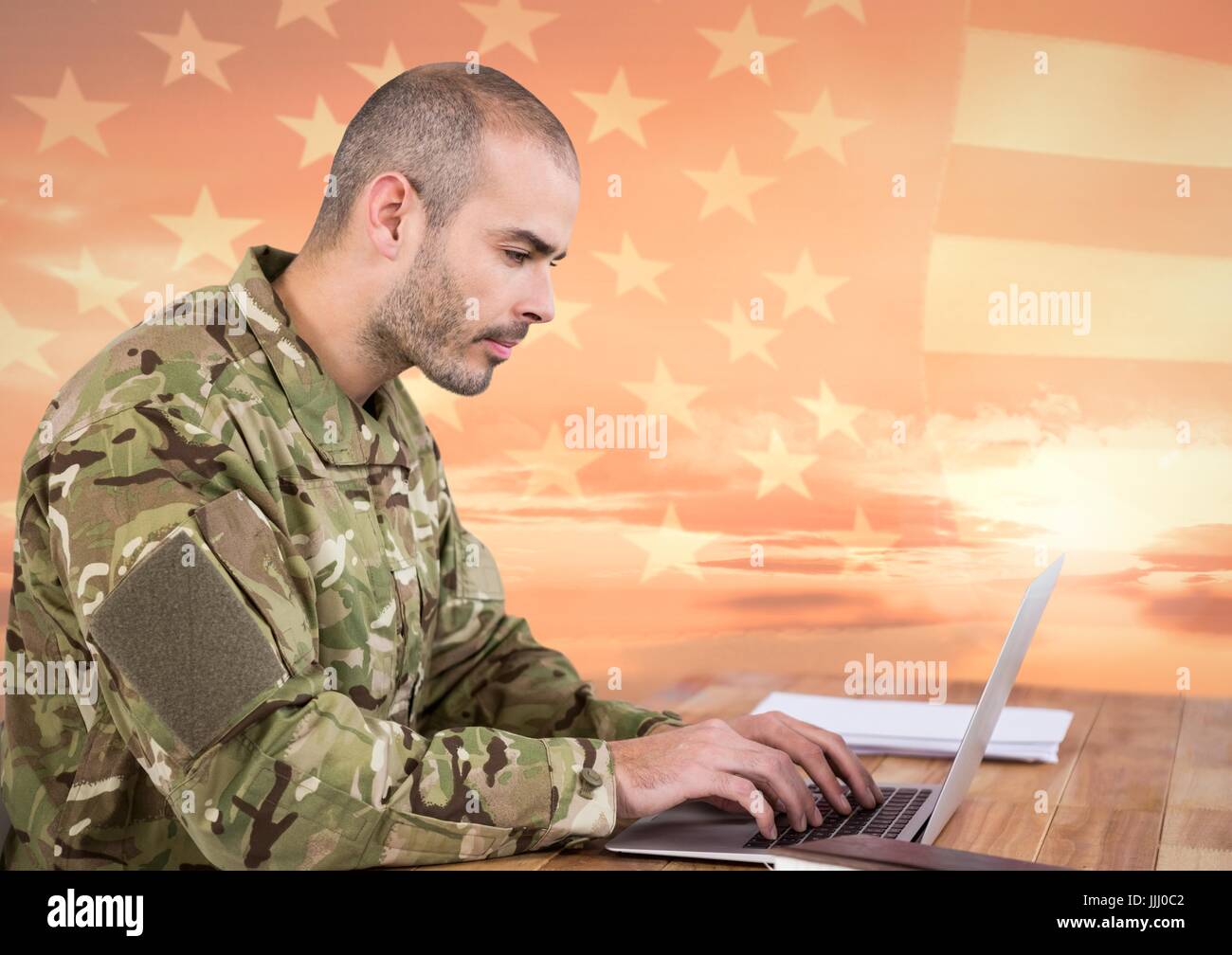 Soldier using a laptop in front of american flag Stock Photo - Alamy