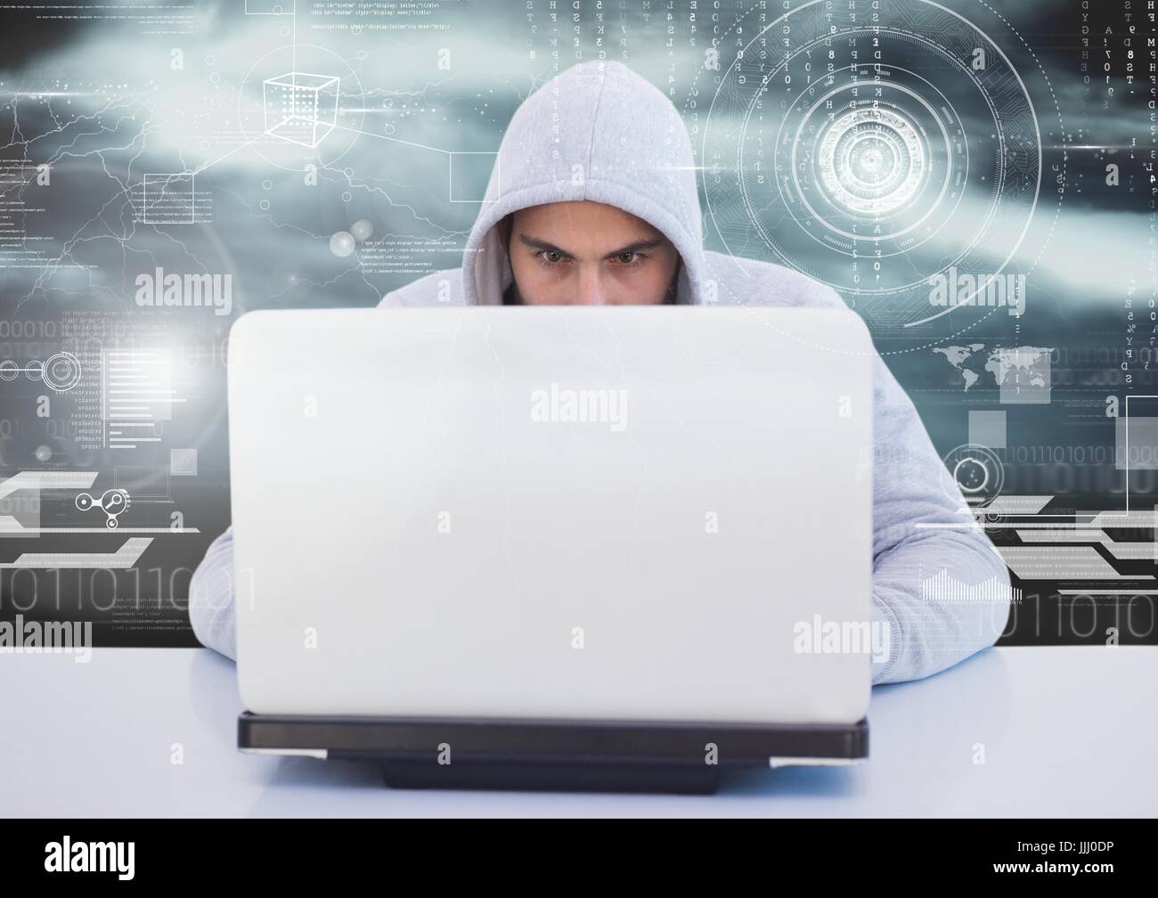 Hacker using a laptop in front of digital background Stock Photo - Alamy