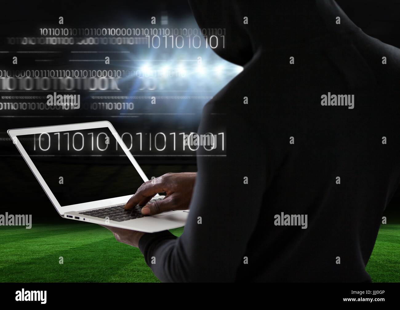 View from the back of hacker using a laptop Stock Photo - Alamy
