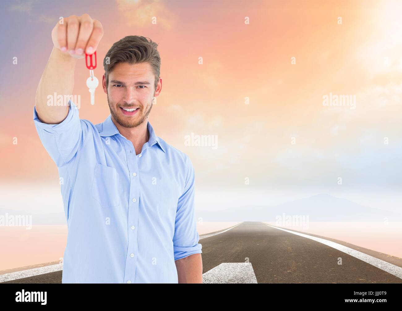 Man Holding Keys with road Stock Photo - Alamy