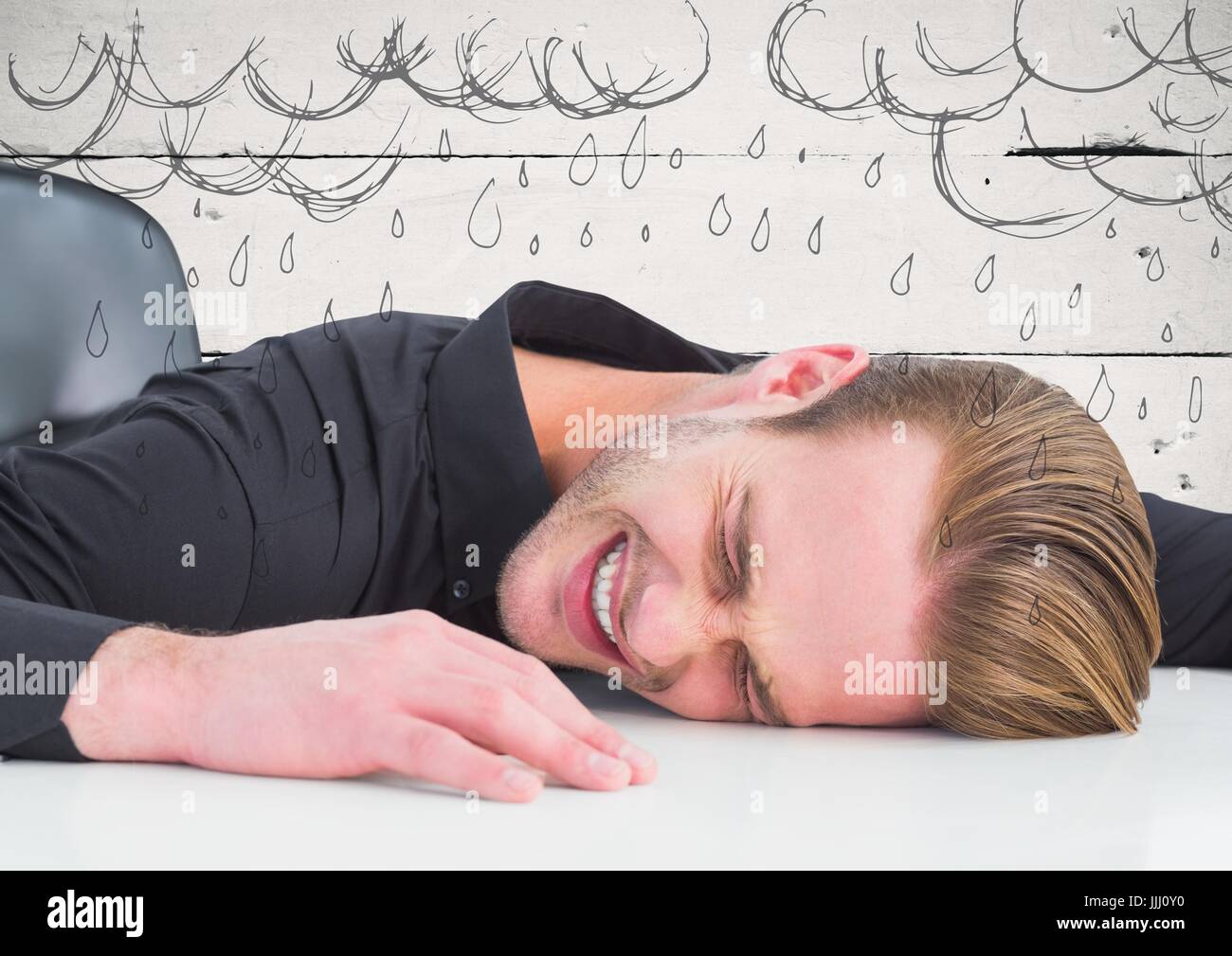 Frustrated business man at desk against white wood panel and rain ...