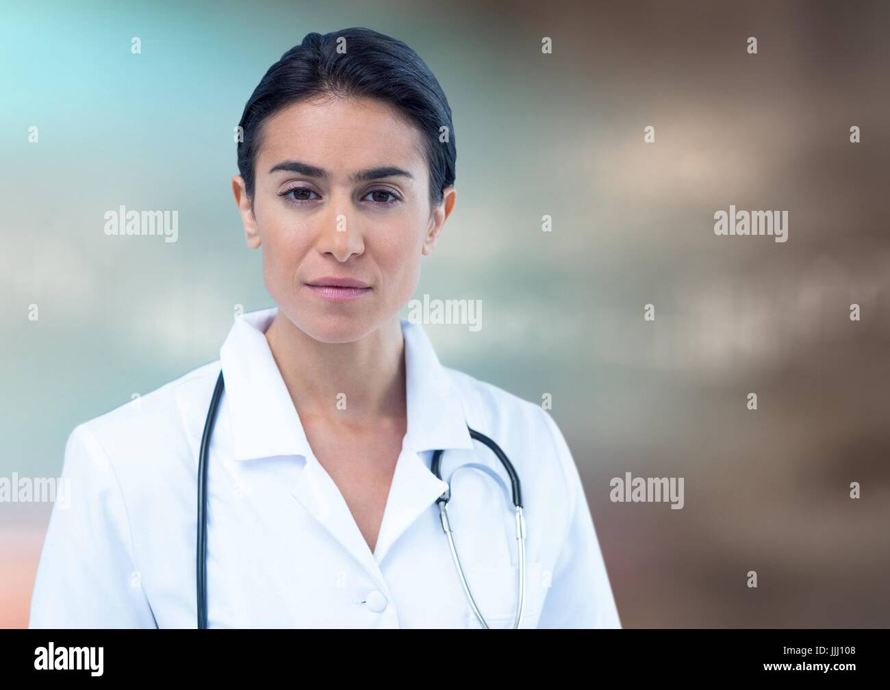 Female doctor against blurry blue brown background Stock Photo - Alamy