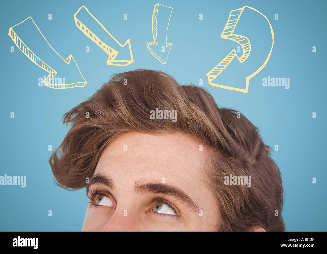 Top of man's head looking at yellow arrows against blue background ...