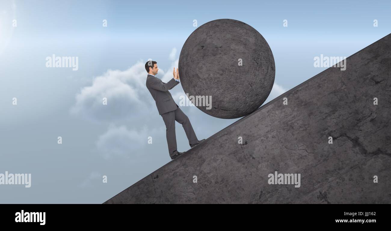 Man pushing rolling round rock Stock Photo - Alamy