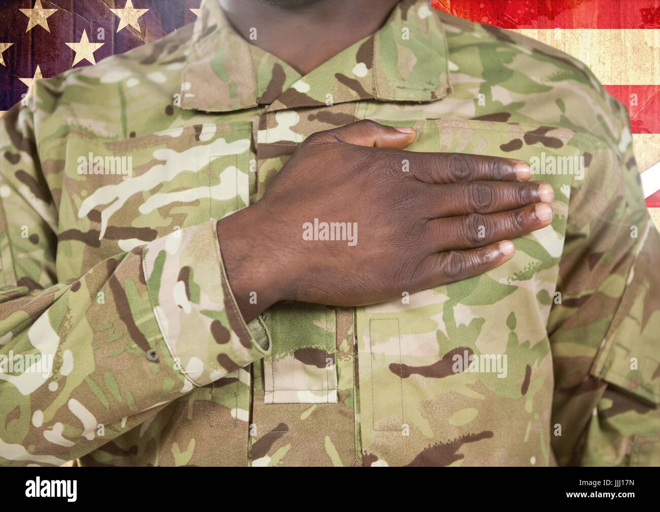 Close up of soldier with hand on heart in front of american flag Stock ...
