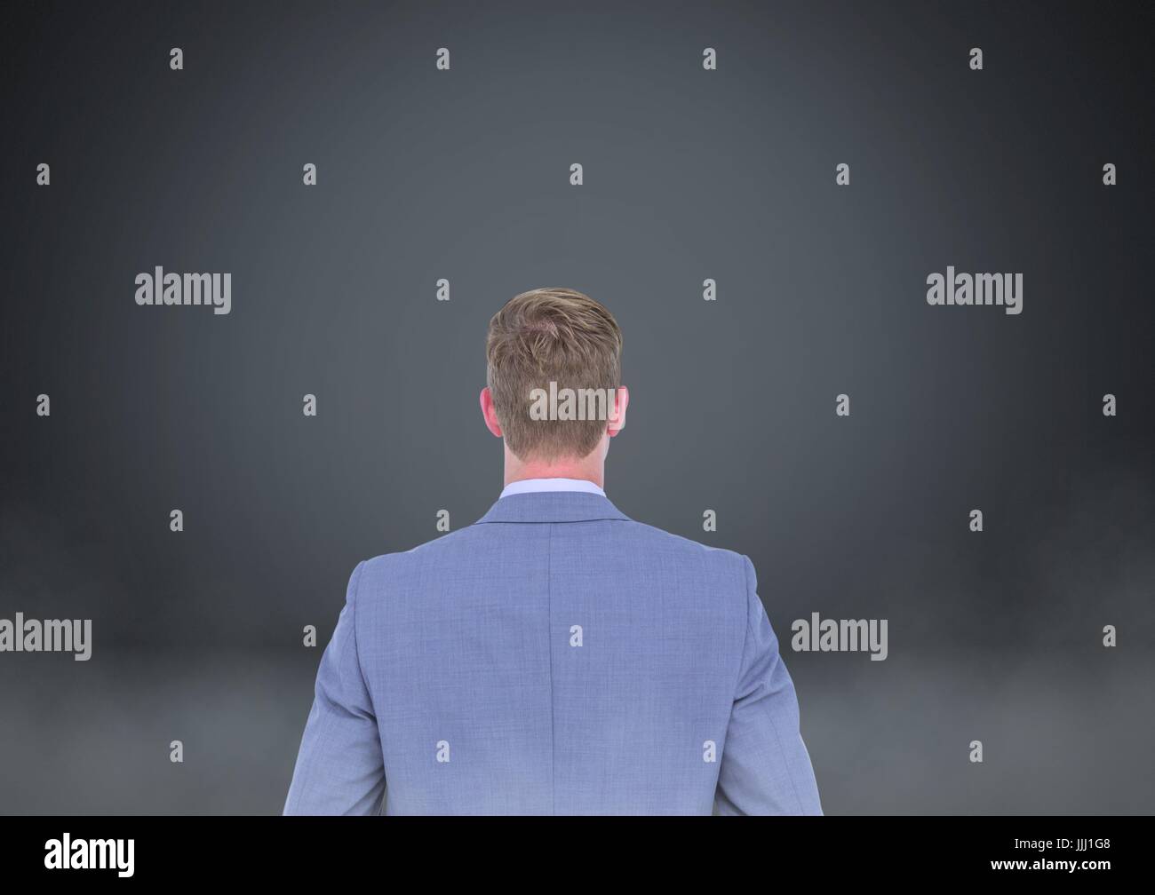 Back of Man Looking at vignette against grey background Stock Photo - Alamy