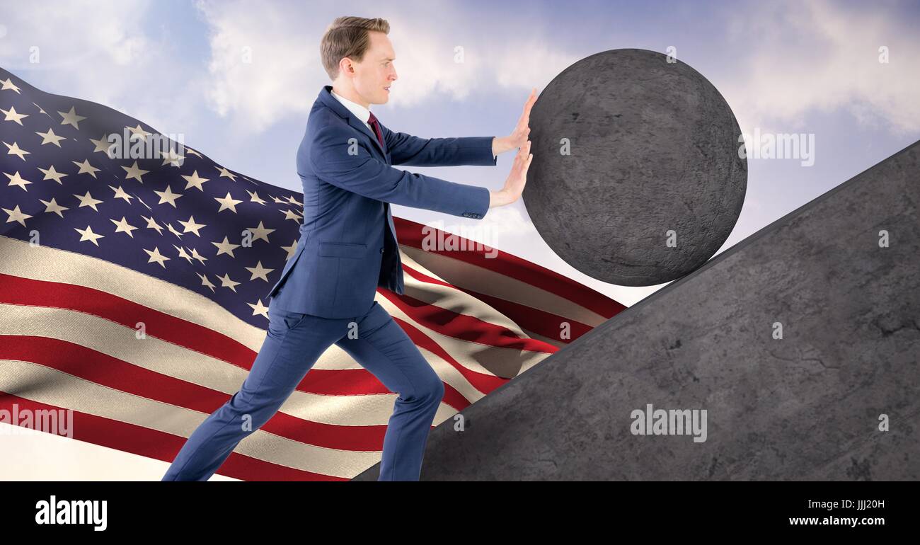 Man pushing rolling round rock Stock Photo - Alamy