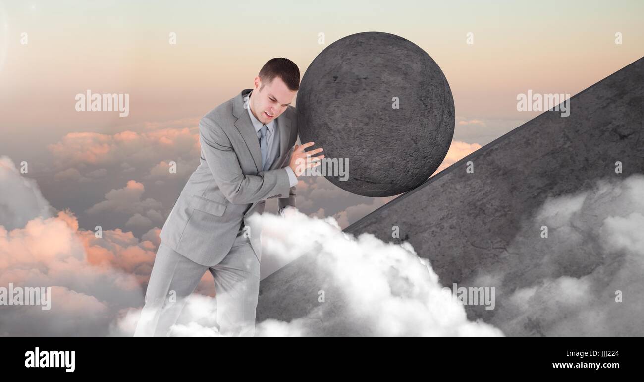 Man pushing rolling round rock Stock Photo - Alamy