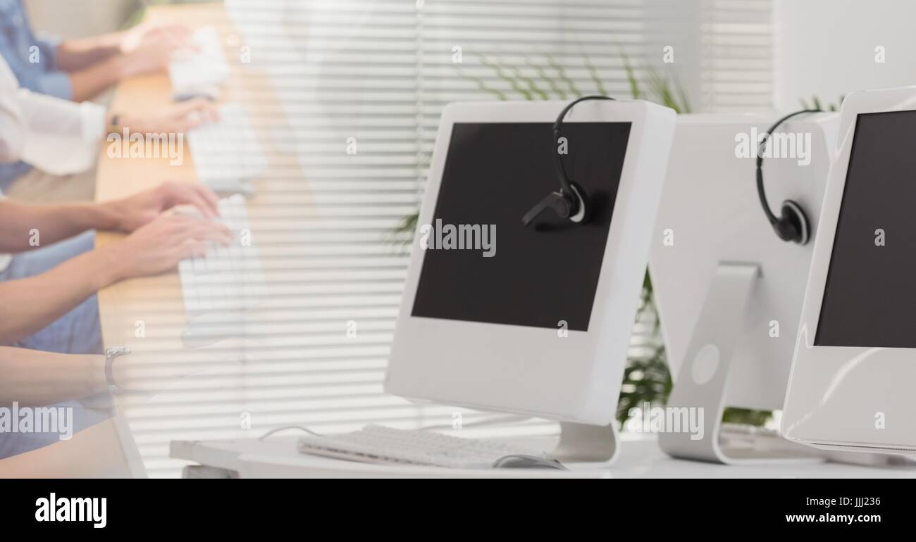 Customer service assistants with headsets with bright computers ...