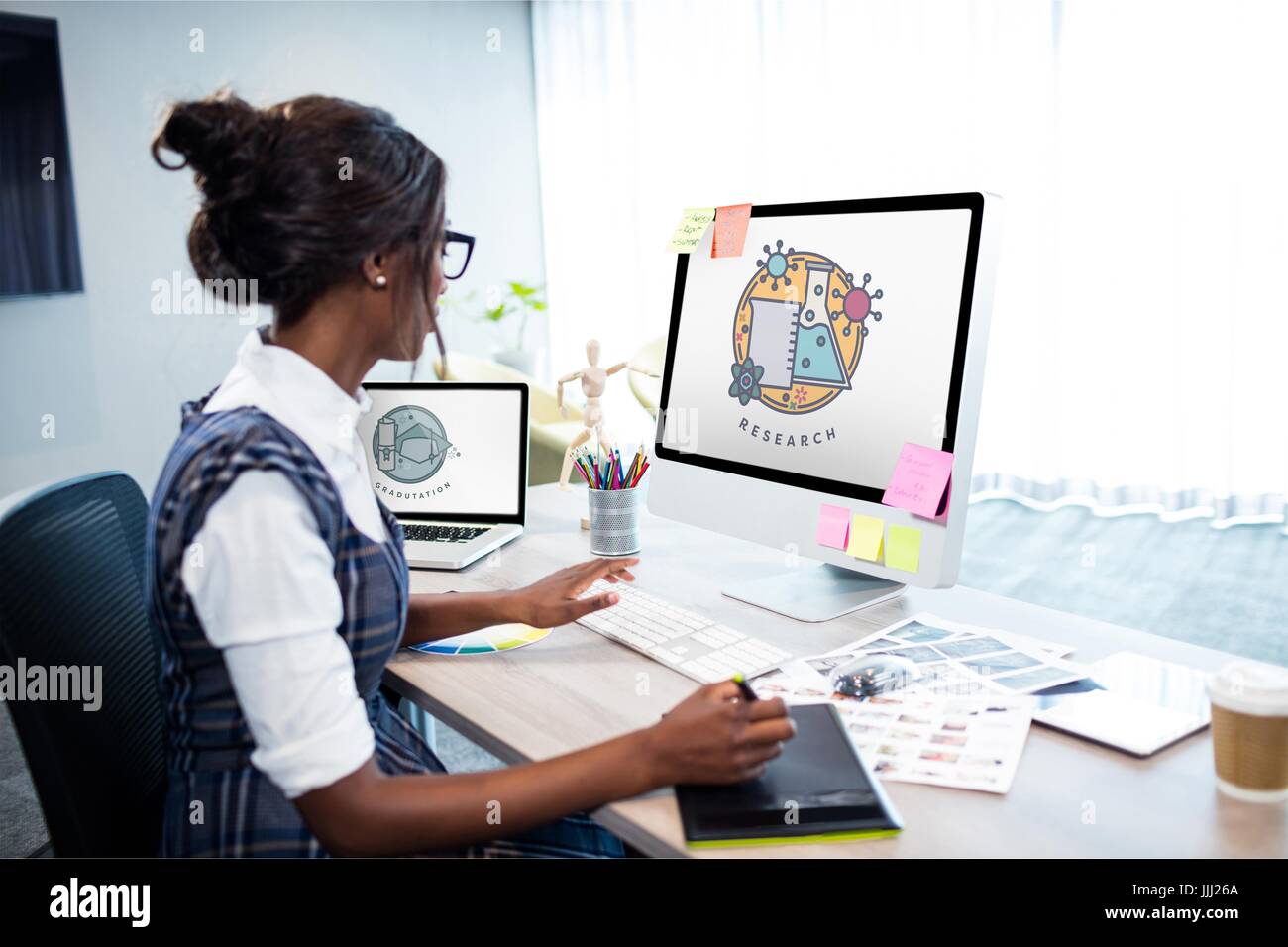 Girl using computers with education icons on the screen Stock Photo - Alamy