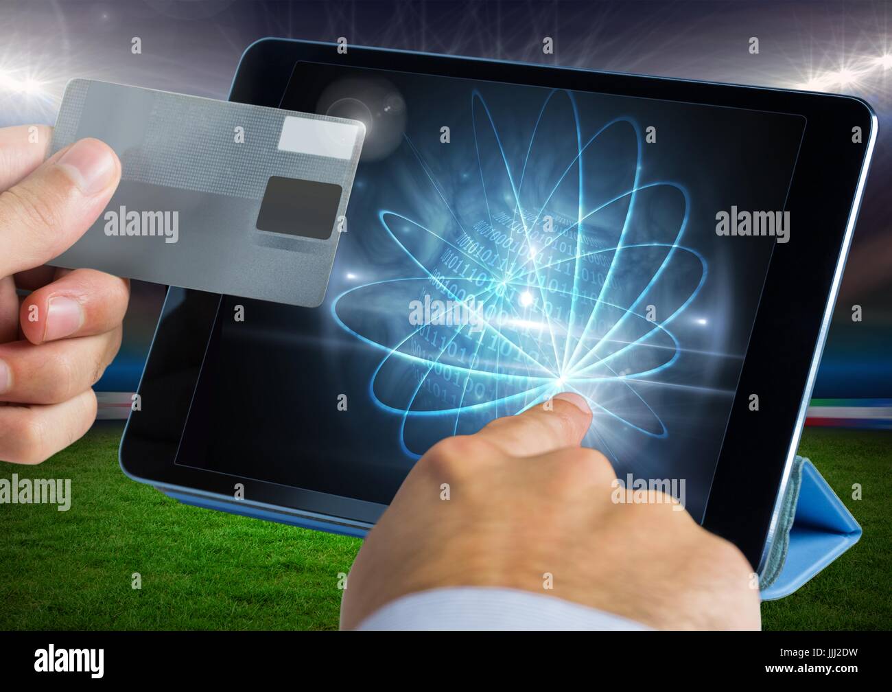 Hands holding a credit card and touching the screen of a tablet in ...