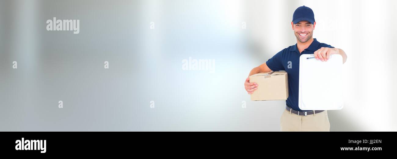 Delivery Courier holding parcel and form in front of blurred background ...