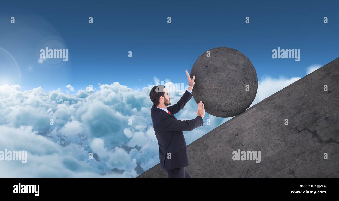 Man pushing rolling round rock Stock Photo - Alamy