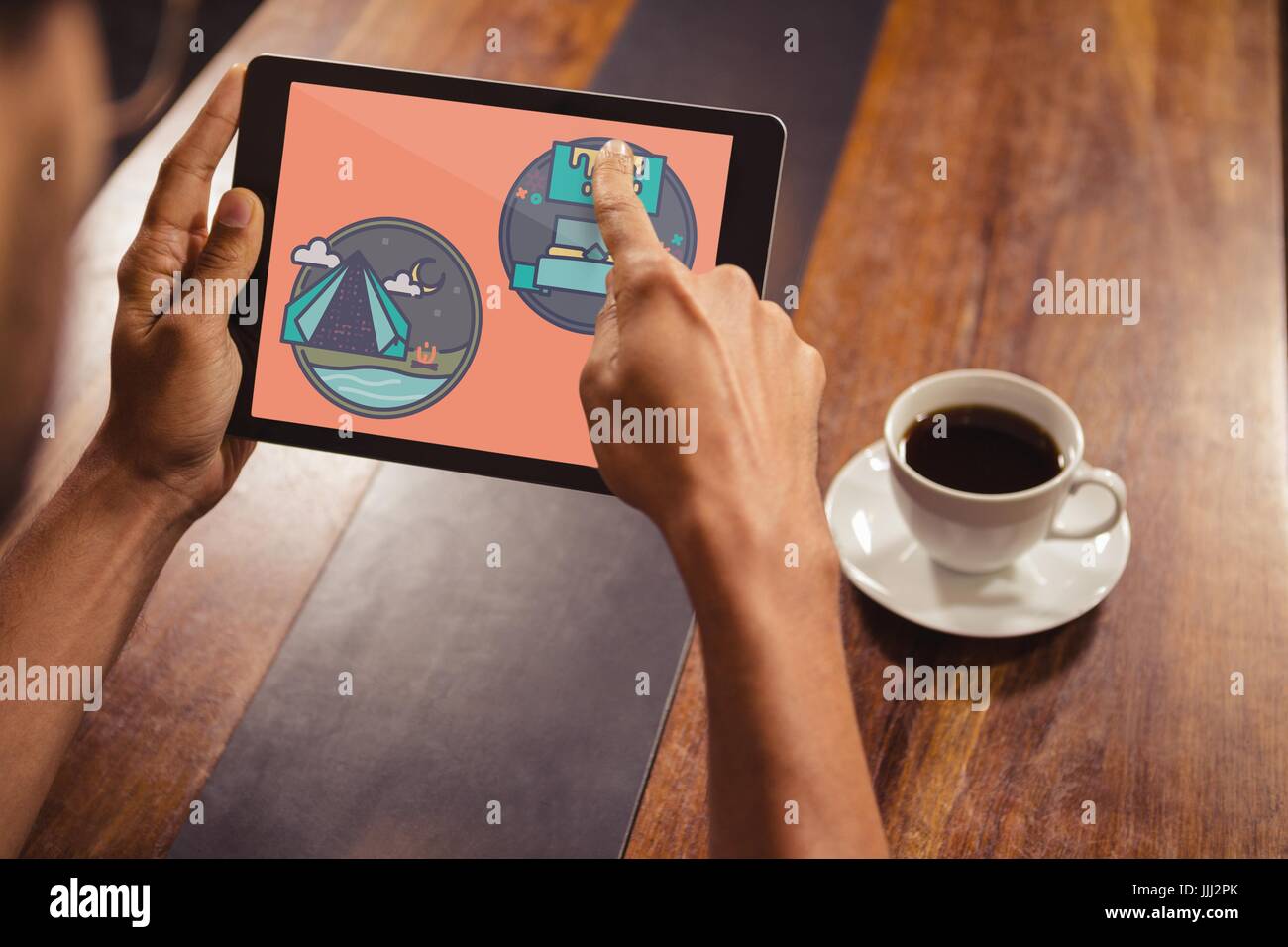 Person holding a tablet with travel icons on the screen Stock Photo - Alamy