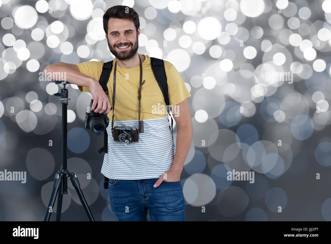 Smiling cameraman on a spotlight background Stock Photo - Alamy