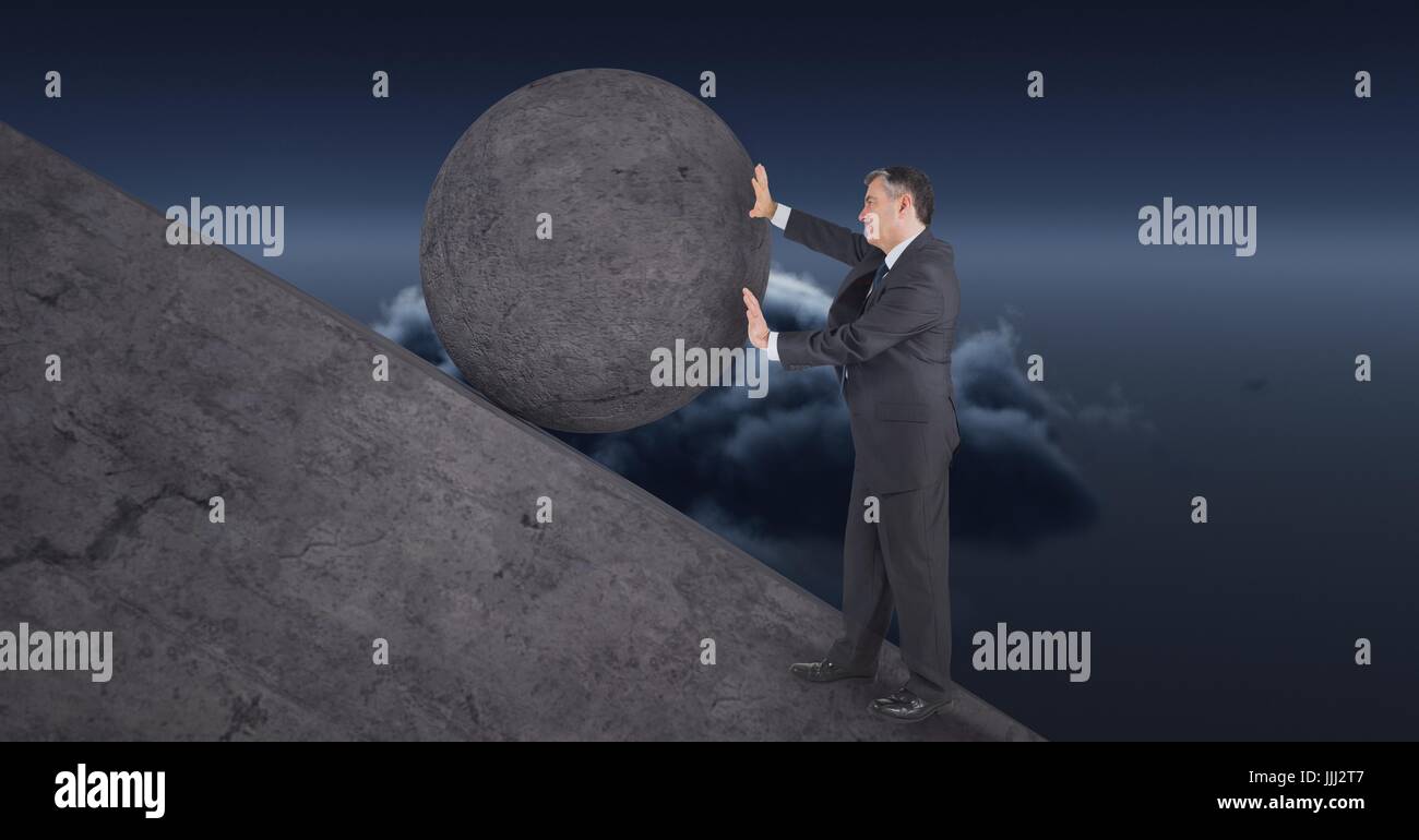 Man pushing rolling round rock Stock Photo - Alamy