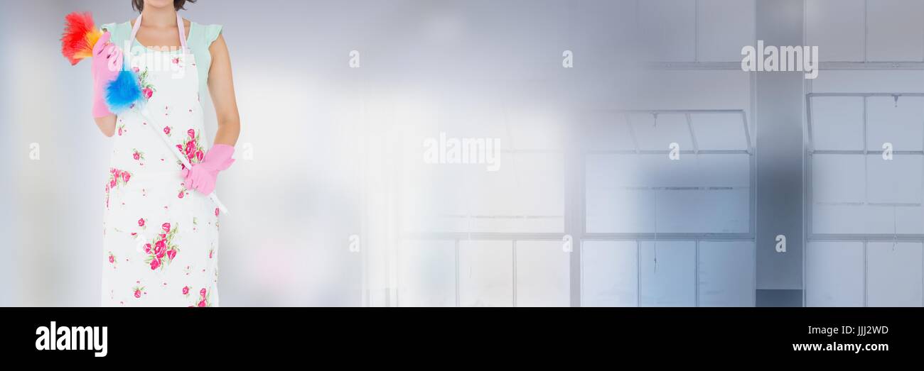 Cleaner holding duster with bright background Stock Photo - Alamy